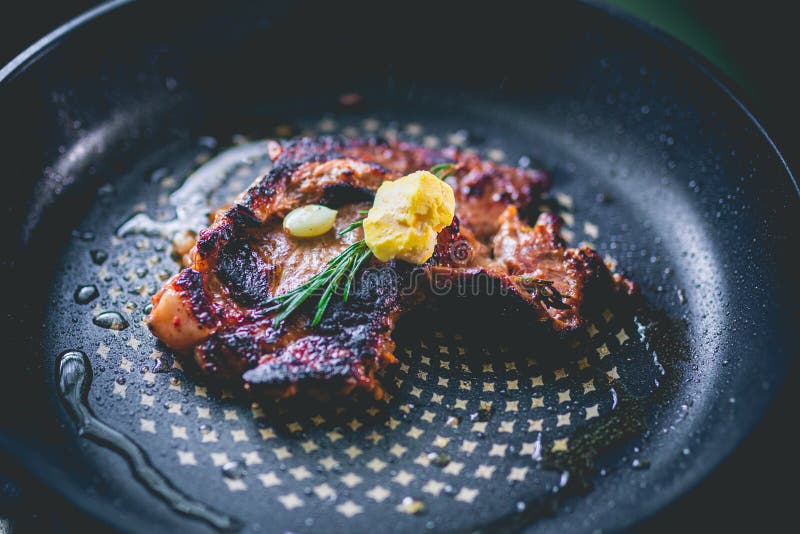 Cooked Beef Steak with Rosemary and Garlic Inside Iron Skillet Stock ...