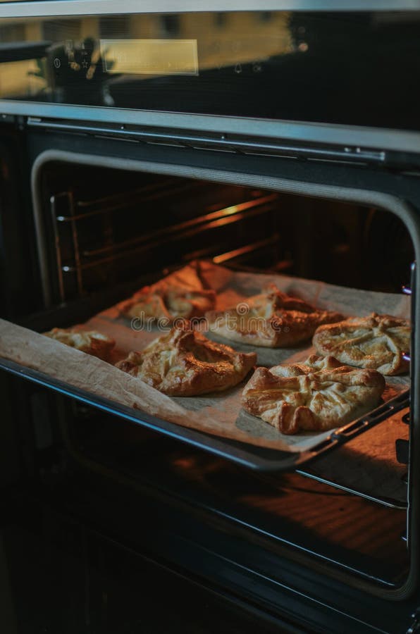 Cooked Buns in the Oven with an Open Door in the Kitchen of a ...