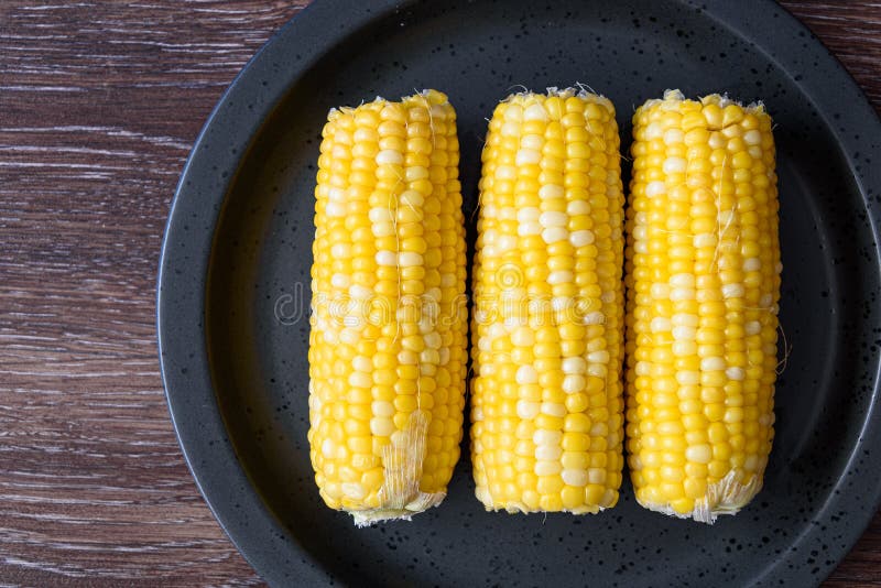 Cooked Corn on the Cob on a Black Plate Stock Photo - Image of yellow ...