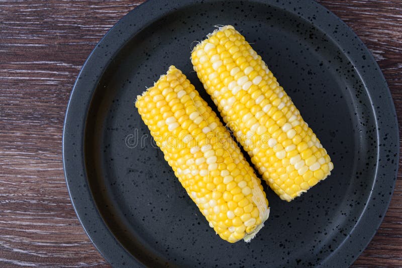 Cooked Corn on the Cob on a Black Plate Stock Photo - Image of yellow ...