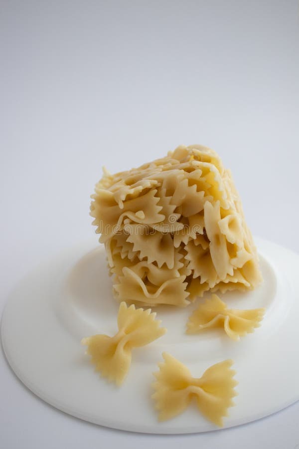 Cooked Farfallini Pasta in a Shape of Cube on a White Inverted Plate ...