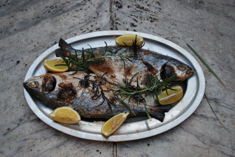 Cooked fish on a platter stock image. Image of health - 11442807