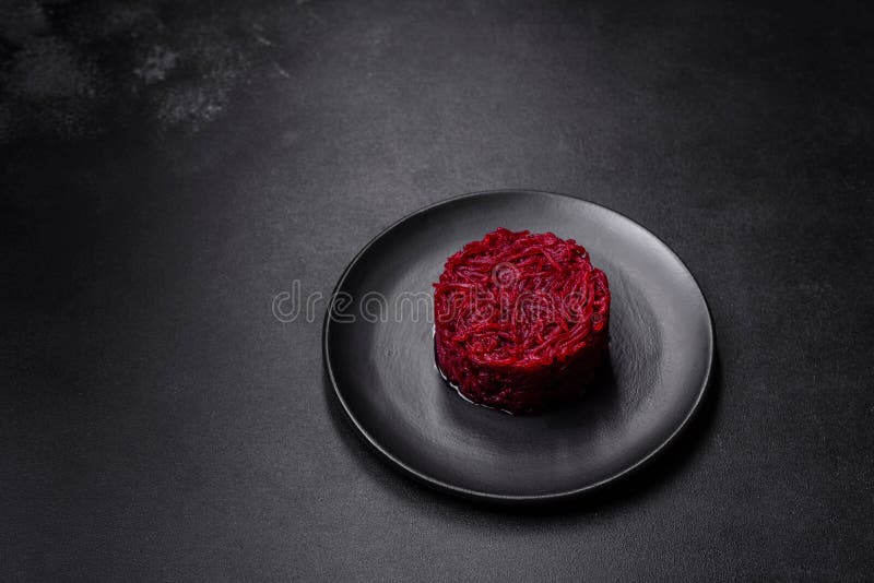 Cooked Grated Beetroot Formed As a Cylinder and Ready Dish on a Black ...