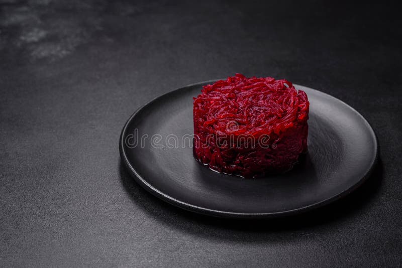 Cooked Grated Beetroot Formed As a Cylinder and Ready Dish on a Black ...