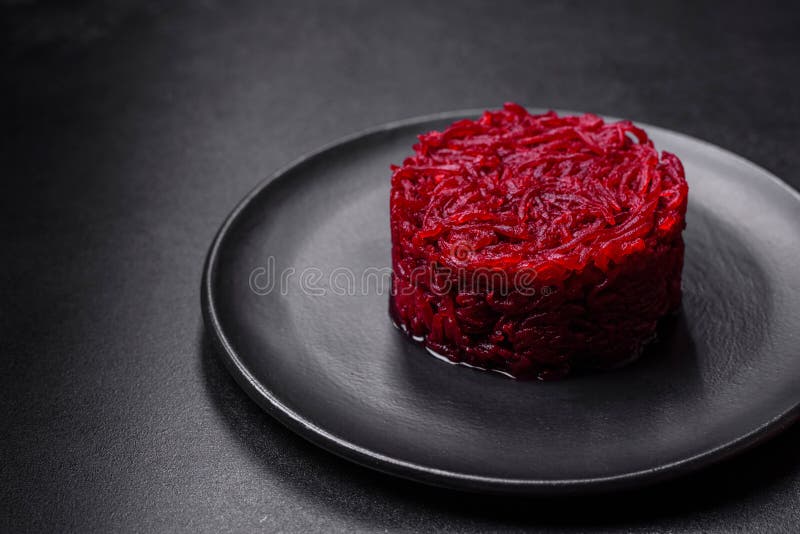 Cooked Grated Beetroot Formed As a Cylinder and Ready Dish on a Black ...