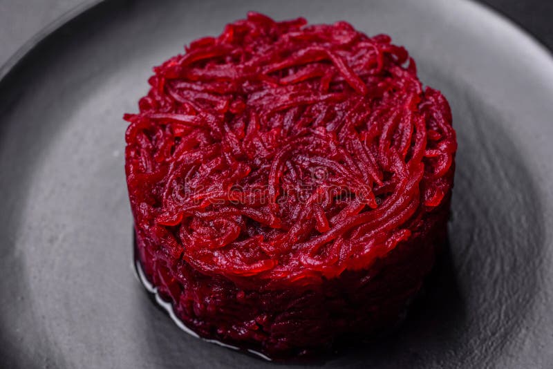 Cooked Grated Beetroot Formed As a Cylinder and Ready Dish on a Black ...