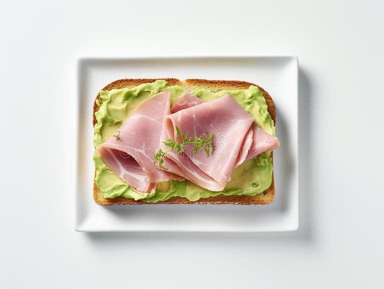 Cooked Ham on a Rectangular Piece of Bread Spread with Avocado Purée ...