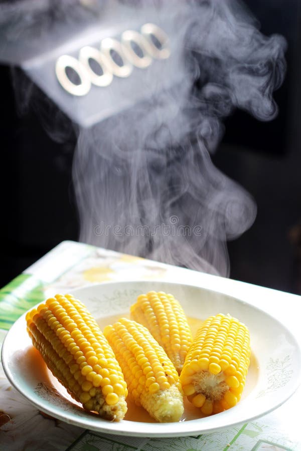 Cooked Hot Yellow Sweet Corn on Plate with Steam on the Dinner Table ...