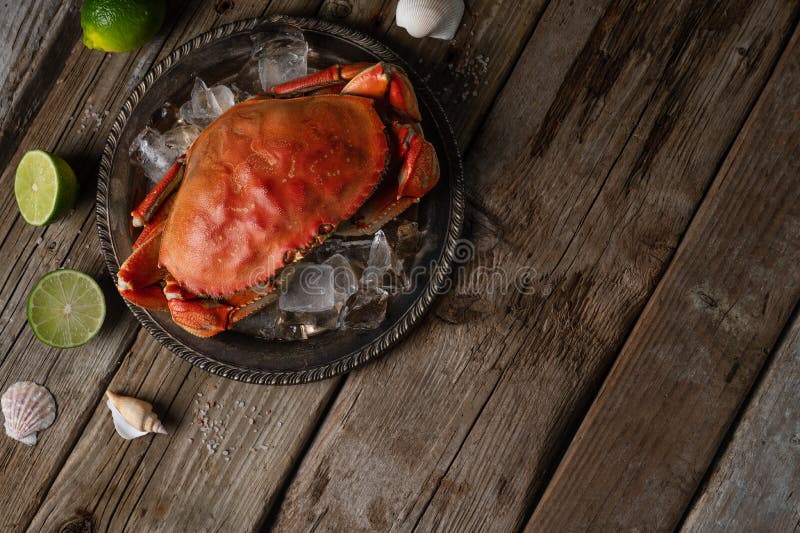 Cooked King Crab on the Round Black Plate with Ice Cube on Rustic ...