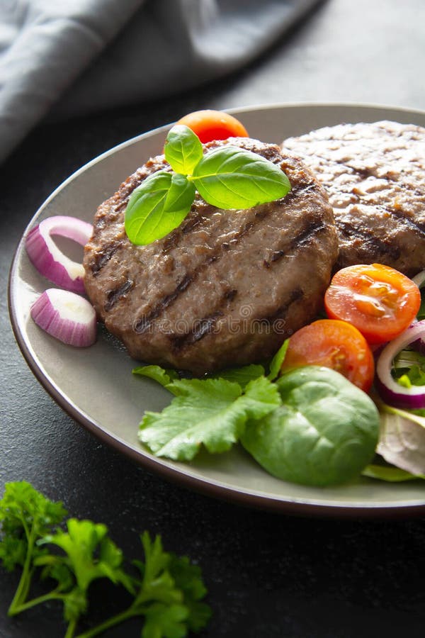 Cooked Minced Beef Patty with Vegetables. Dark Background Stock Image ...
