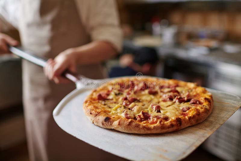 Cooked pizza stock photo. Image of homemade, hand, cooking - 76285710
