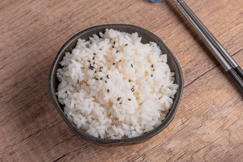 Cooked Rice in a Cup of Black Thai Jasmine Rice Stock Photo - Image of ...