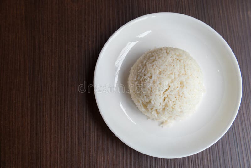 Cooked rice in white dish stock photo. Image of circle - 124797352