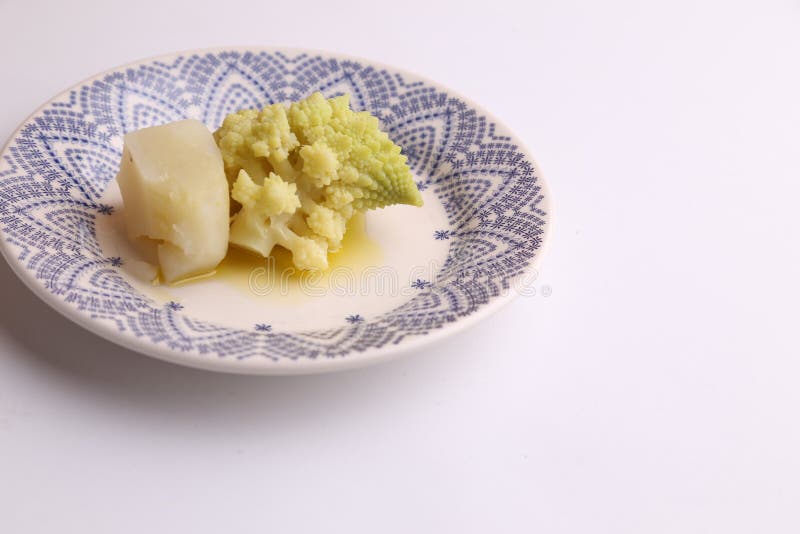 Cooked Romanesco Broccoli and the Potato on the Plate on the White ...