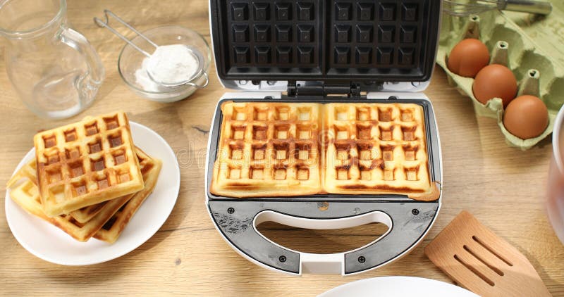 Cooked Waffles in Electric Waffle Iron. Stock Photo - Image of closeup ...