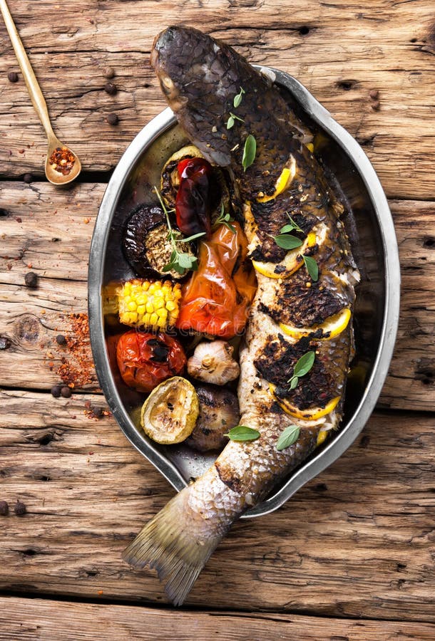 Grilled fish in a tray stock photo. Image of food, table - 100887996