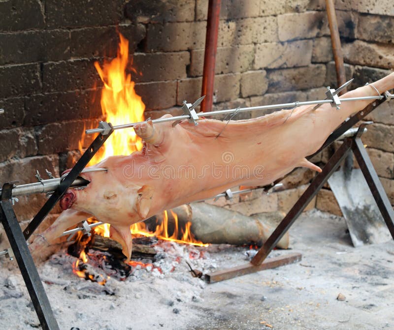 Cooked Whole Pig on a Spit with Hot Embers Stock Photo - Image of ...