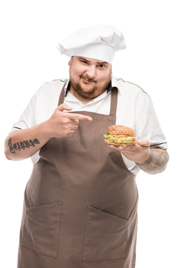 Cooker in Apron Pointing at Burger in Hand Stock Photo - Image of ...