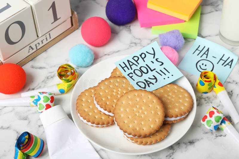 Cookies with Toothpaste and HAPPY FOOL`S DAY Note on White Marble Table ...