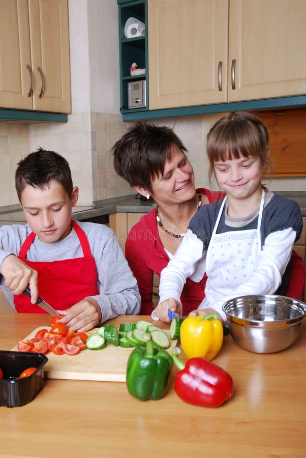 Family cooking in kitchen stock image. Image of spoon - 17916853