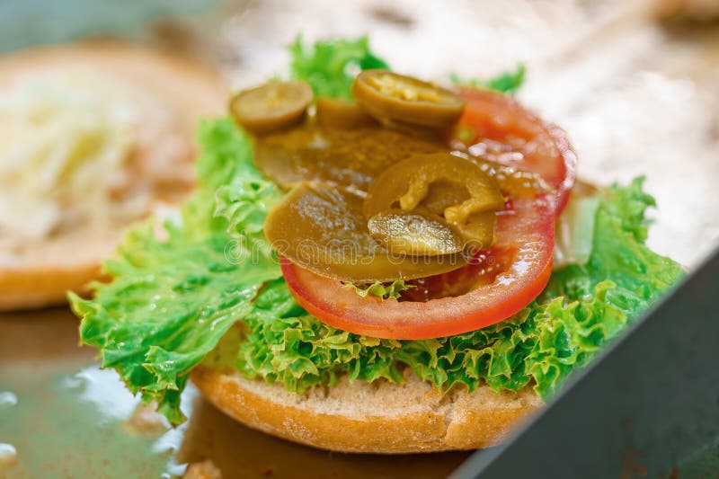 Cooking a Bacon Burger and Cutlet with Salad and Cheese in a Restaurant ...