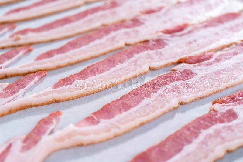 Cooking bacon strips stock photo. Image of uncooked - 252988550