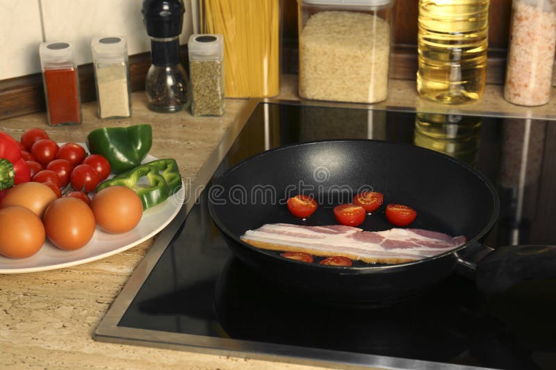 Cooking Bacon with Tomatoes in Frying Pan. Ingredients for Breakfast ...