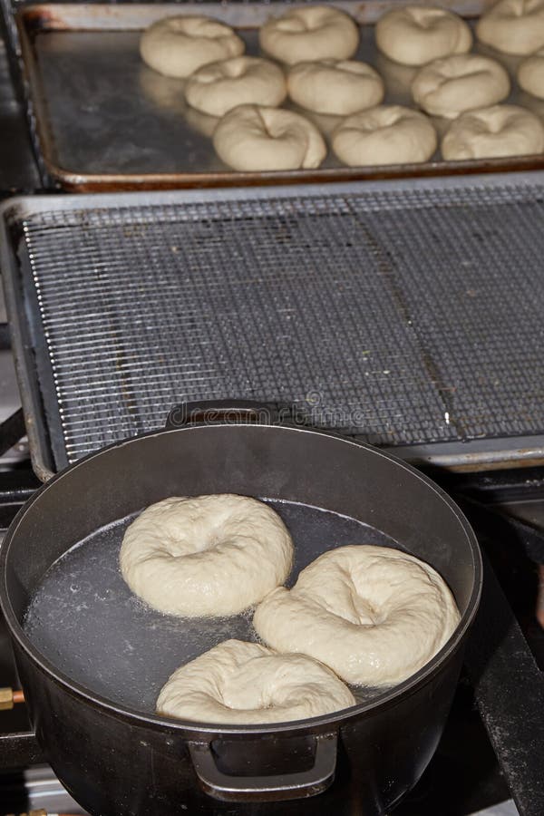Cooking bagel in hot water stock photo. Image of dough - 118422340