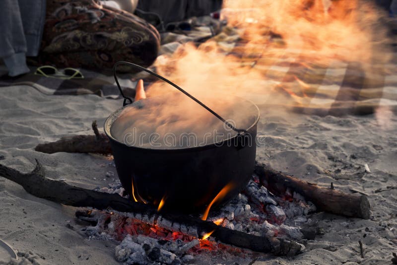 Cooking on the beach stock image. Image of equipment - 67570521