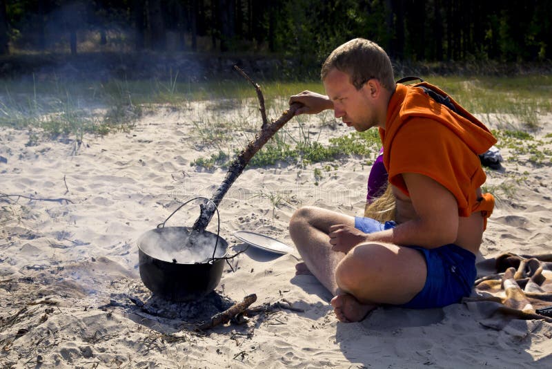 Cooking on the beach stock image. Image of exploration - 67570547