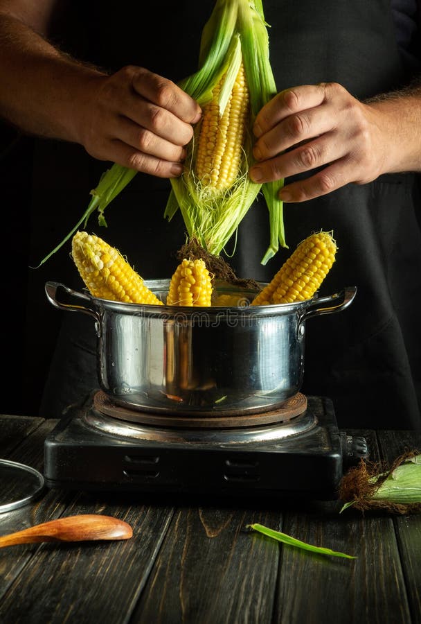 Man Cleans the Ear of Corn with His Hand Stock Image - Image of glove ...
