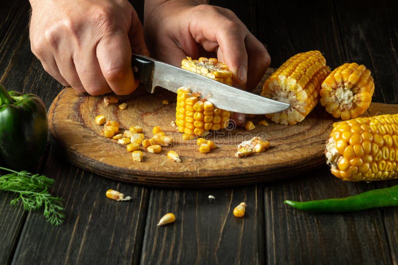 Cooking Boiled Maize in the Kitchen by the Hands of a Cook. Chef Hands ...