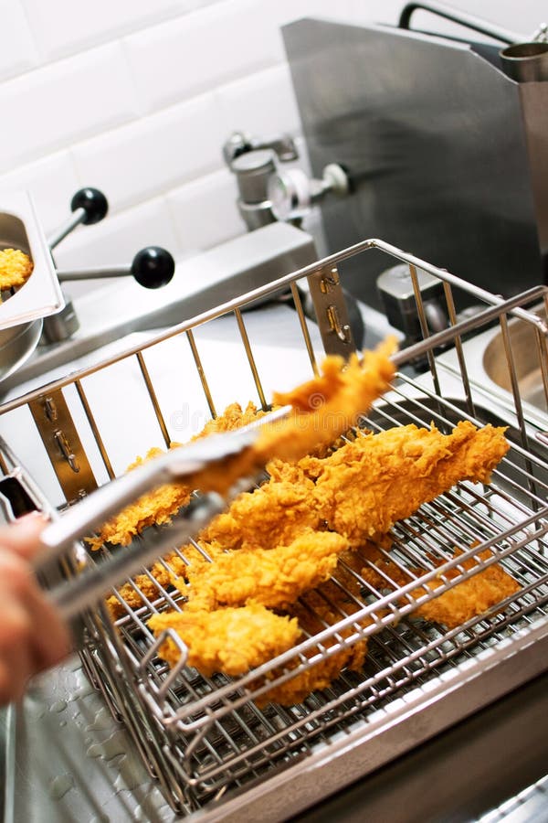 Cooking Breaded Chicken Slices in the Kitchen in a Restaurant Stock ...