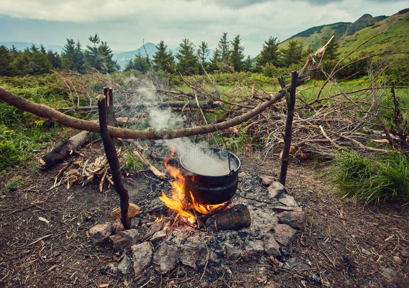 Cooking Breakfast on Fire in Mountains Stock Photo - Image of black ...