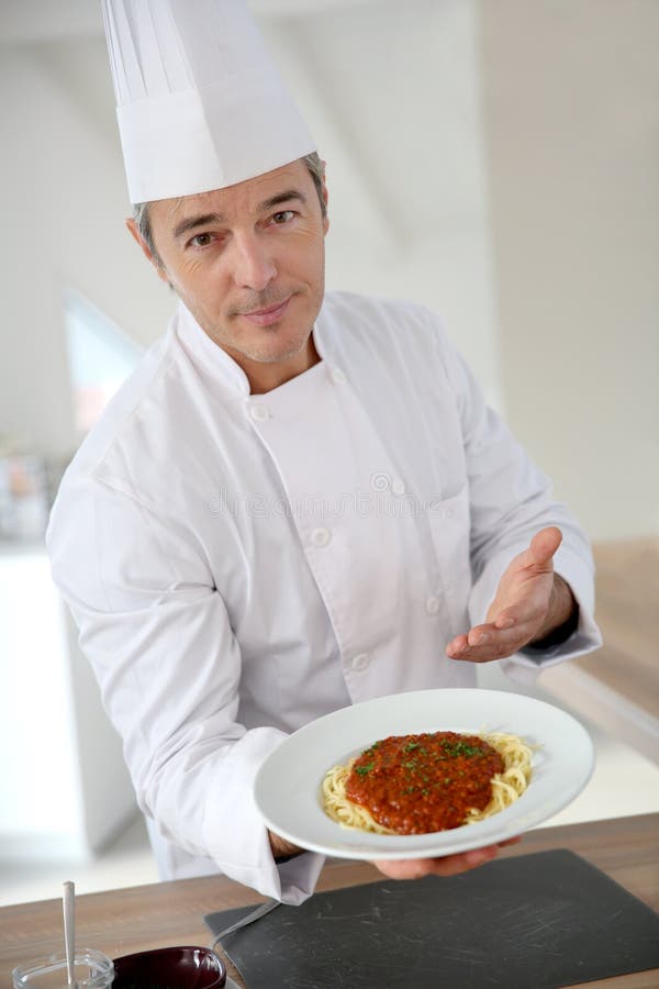 Cooking Chef in the Kitchen Holding Dish of Pasta Stock Image - Image ...