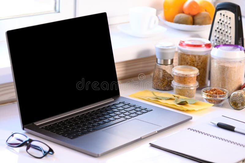 .Cooking Courses. There is a Laptop on the Table and a Lot of Products ...
