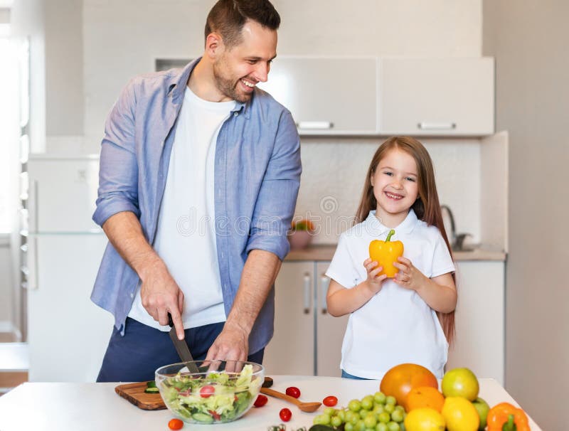 Father and Daughter Preparing Dinner Together in Kitchen at Home Stock ...