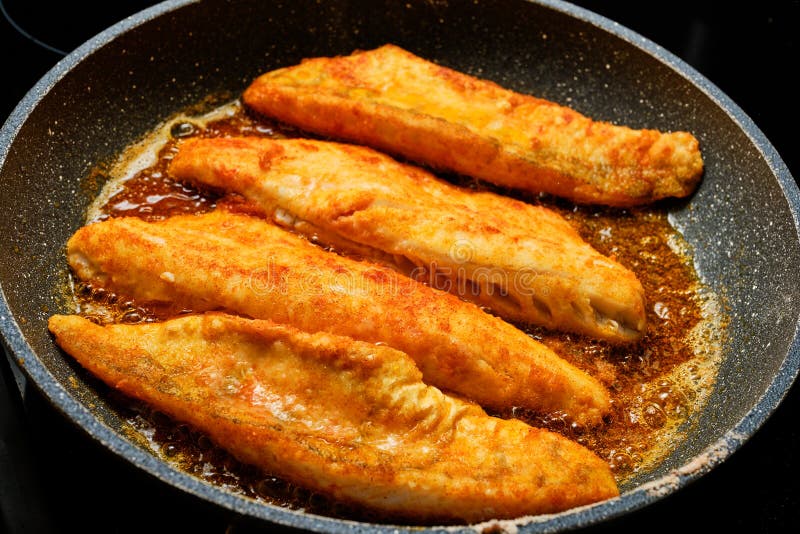 Cooking fish on frying pan stock image. Image of food - 270194987