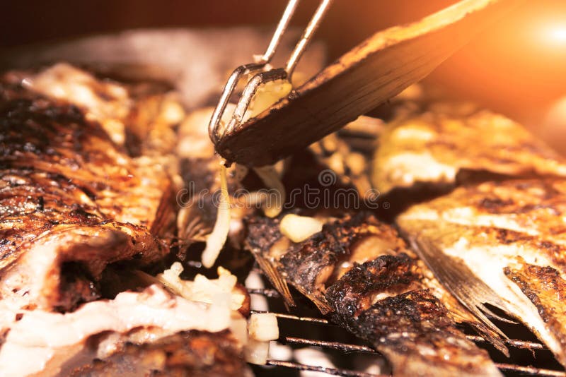 Cooking Fish on the Grill. Fried Fish. Fried Fish on the Fire. Close-up ...