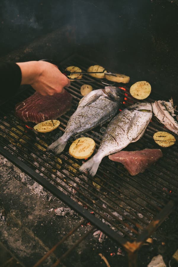Cooking Fish and Potatoes on Grill Stock Photo - Image of roasted ...