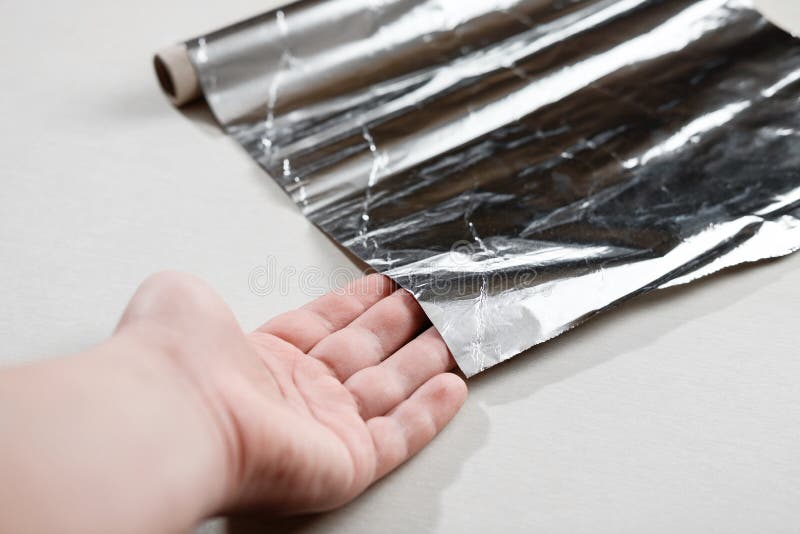 Cooking foil in hand stock image. Image of cover, packaging - 136910553