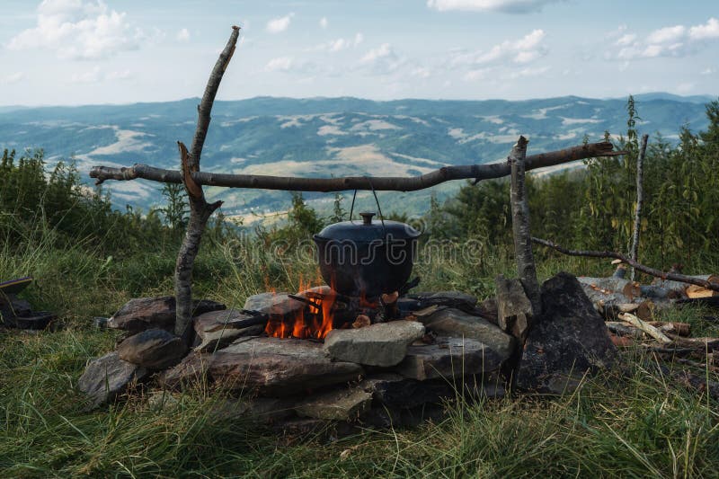Cooking Food on Campfire in Mountains. Camping Season, Cauldron on the ...