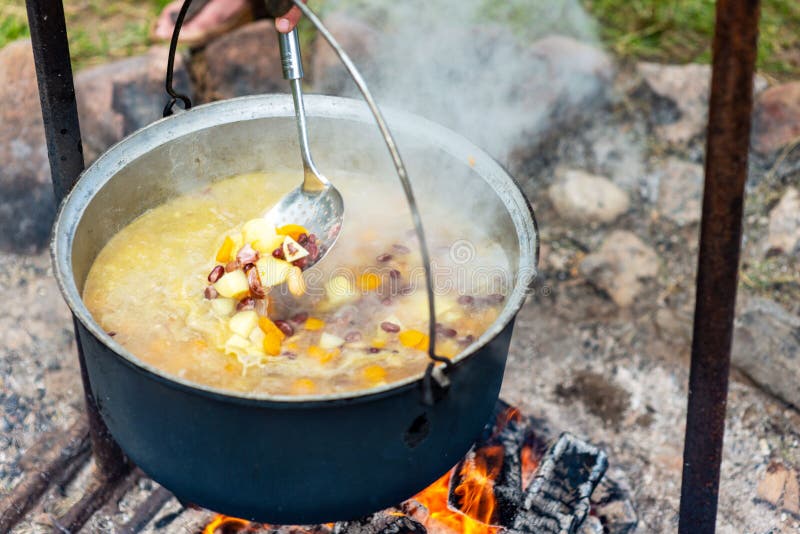 Cooking Food in a Pot on Campfire. Summer Camping Concept Stock Photo ...