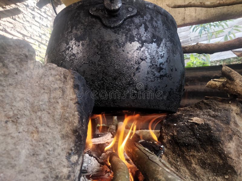 Cooking Food in a Pot with Firewood Using a Three Stone Stove Stock ...