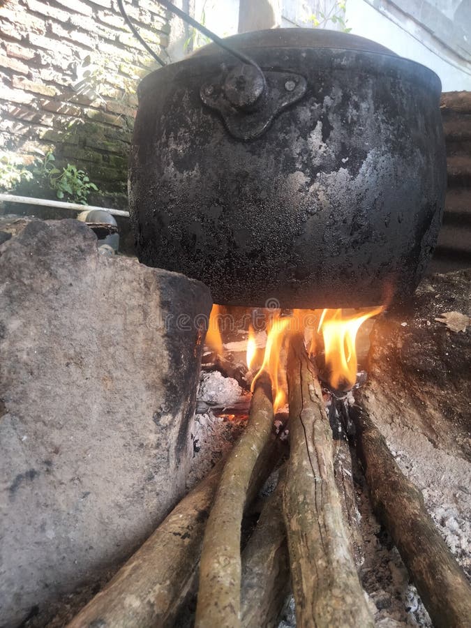 Cooking Food in a Pot with Firewood Using a Three Stone Stove Stock ...