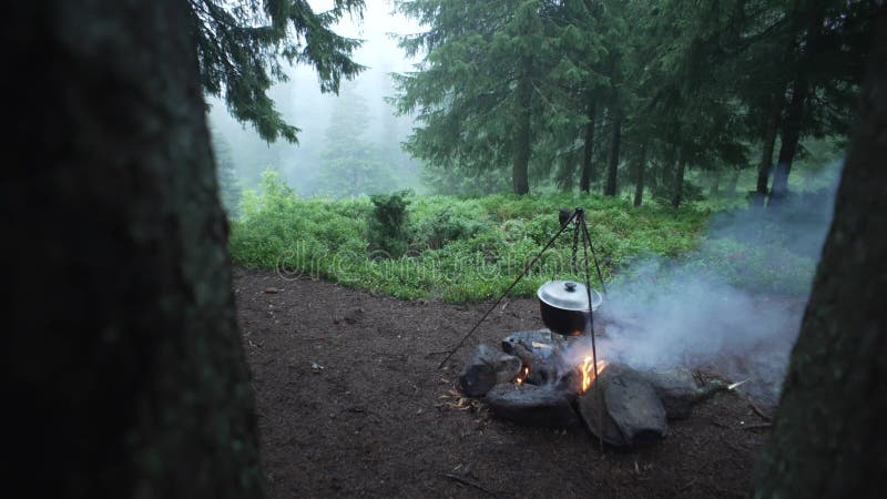 Cooking in the Forest Under the Rain. Cauldron on a Fire in the ...