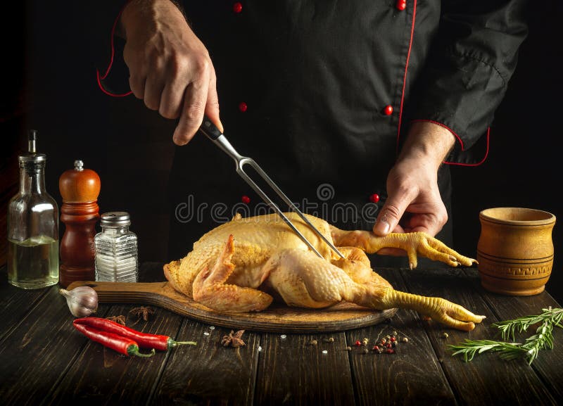 Cutting a Raw Rooster with a Knife in the Hand of a Chef in a ...