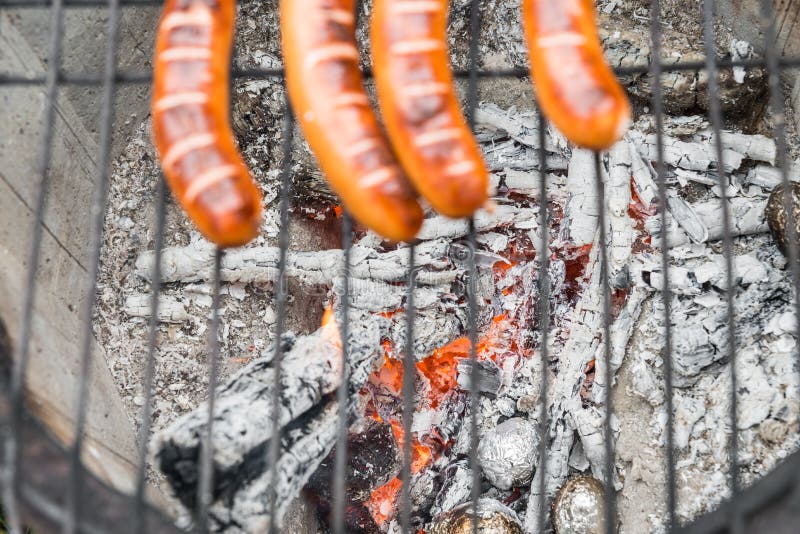 Cooking Grate with Sausages at a Old Fire Pot with Burning Fire Stock ...