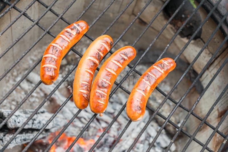 Cooking Grate with Sausages at a Old Fire Pot with Burning Fire Stock ...