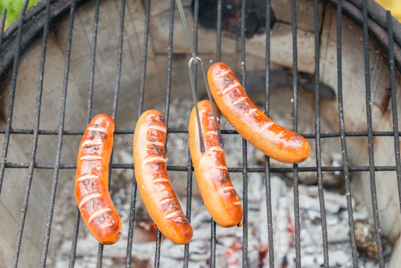 Cooking Grate with Sausages at a Old Fire Pot with Burning Fire Stock ...